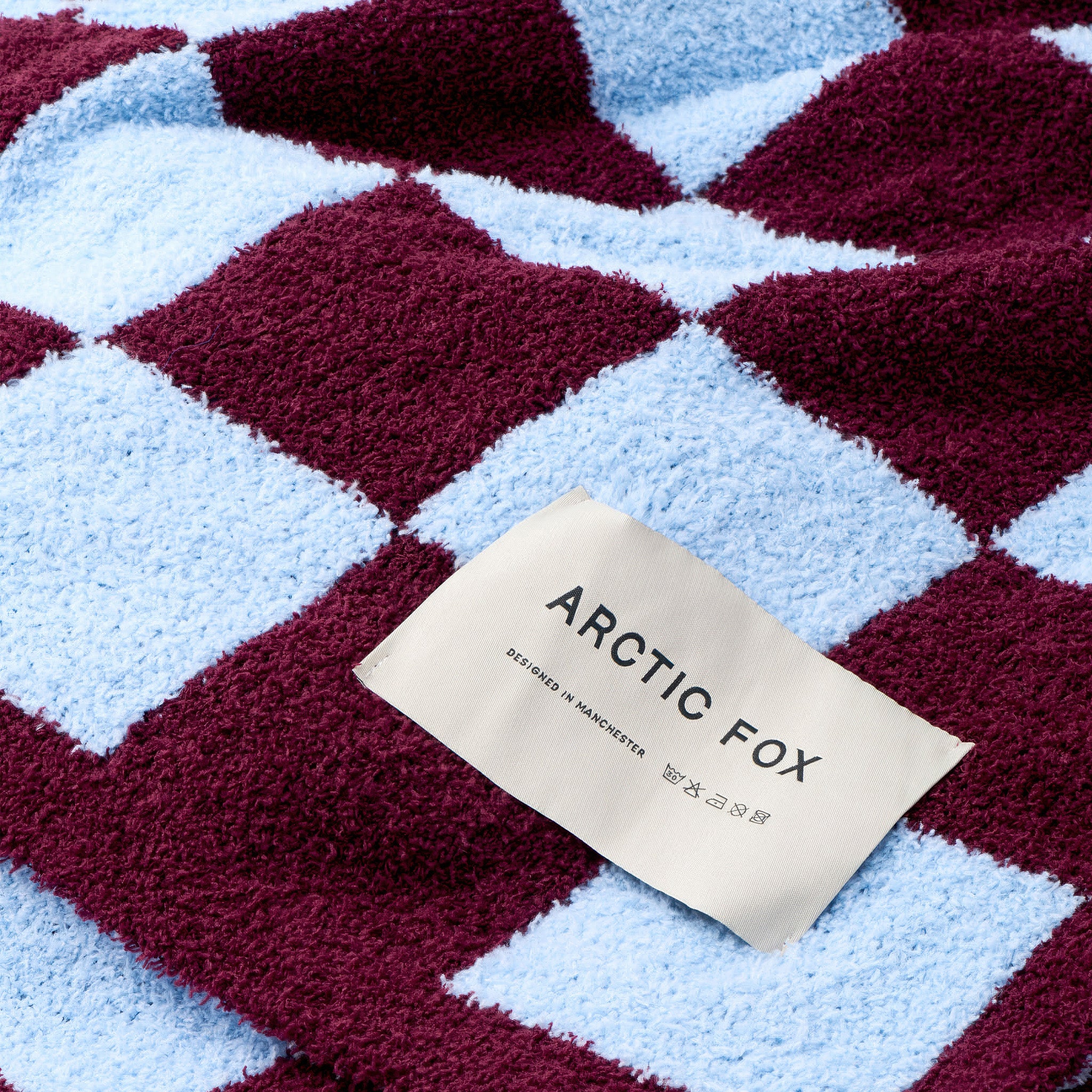 blue teddy with red blanket